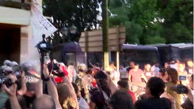 Greek debt crisis: Police fire stun grenades at rally protesters - BBC News