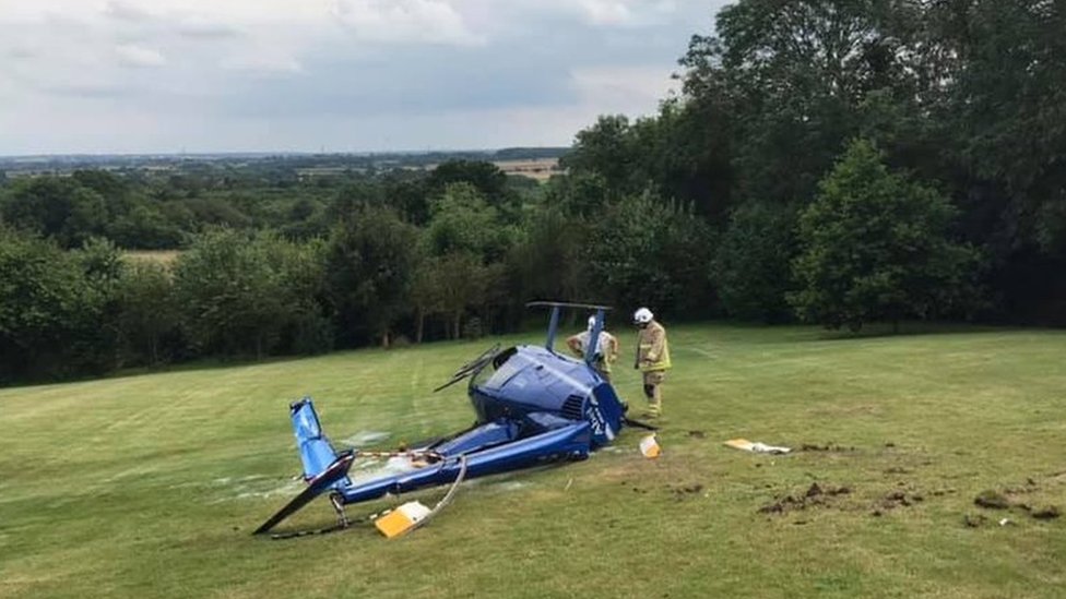 Pilot injured as helicopter overturns in Barwell on take-off - BBC News