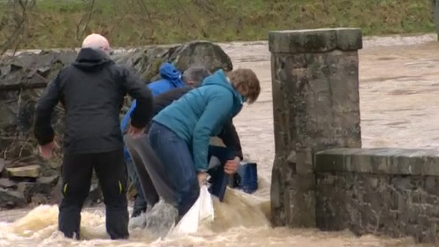 Drone shows historic castle teetering over flood water - BBC News