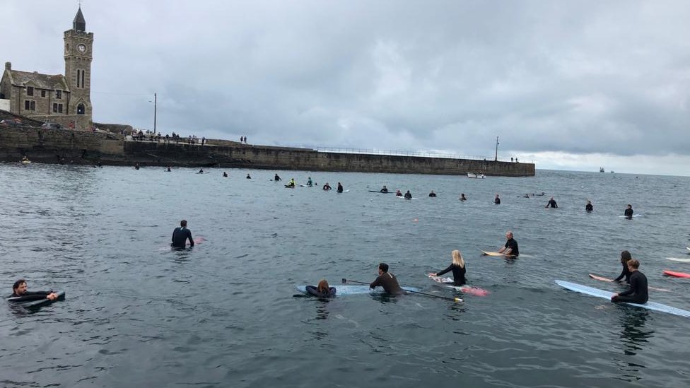 Cornwall surfers paddle out for anti-racism protest - BBC News