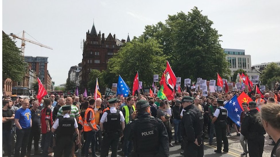 Smoke bombs thrown during Belfast demonstrations - BBC News