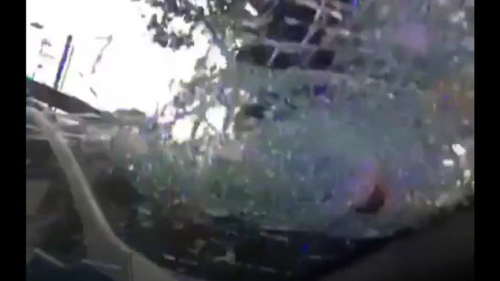 Video appears to show police officer smash car window - BBC News
