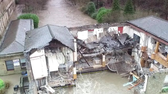 Flood water washes away building - BBC Newsround